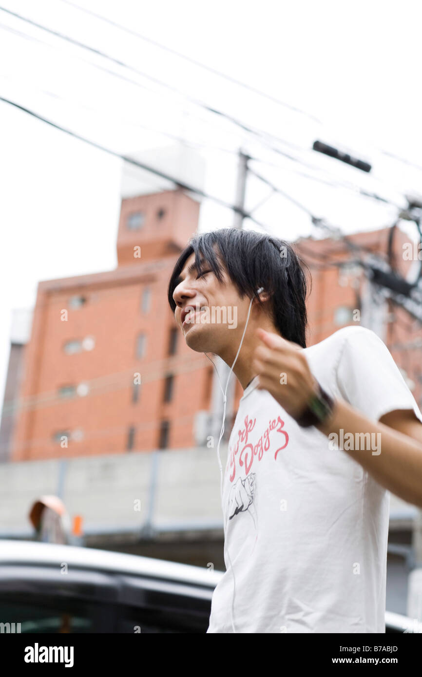 Young man listening to music, iPod, MP3 player, Tokyo, Japan, Asia ...