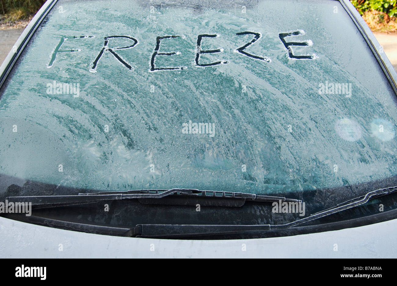The word 'Freeze' written by a finger on a frosty and iced windscreen ...