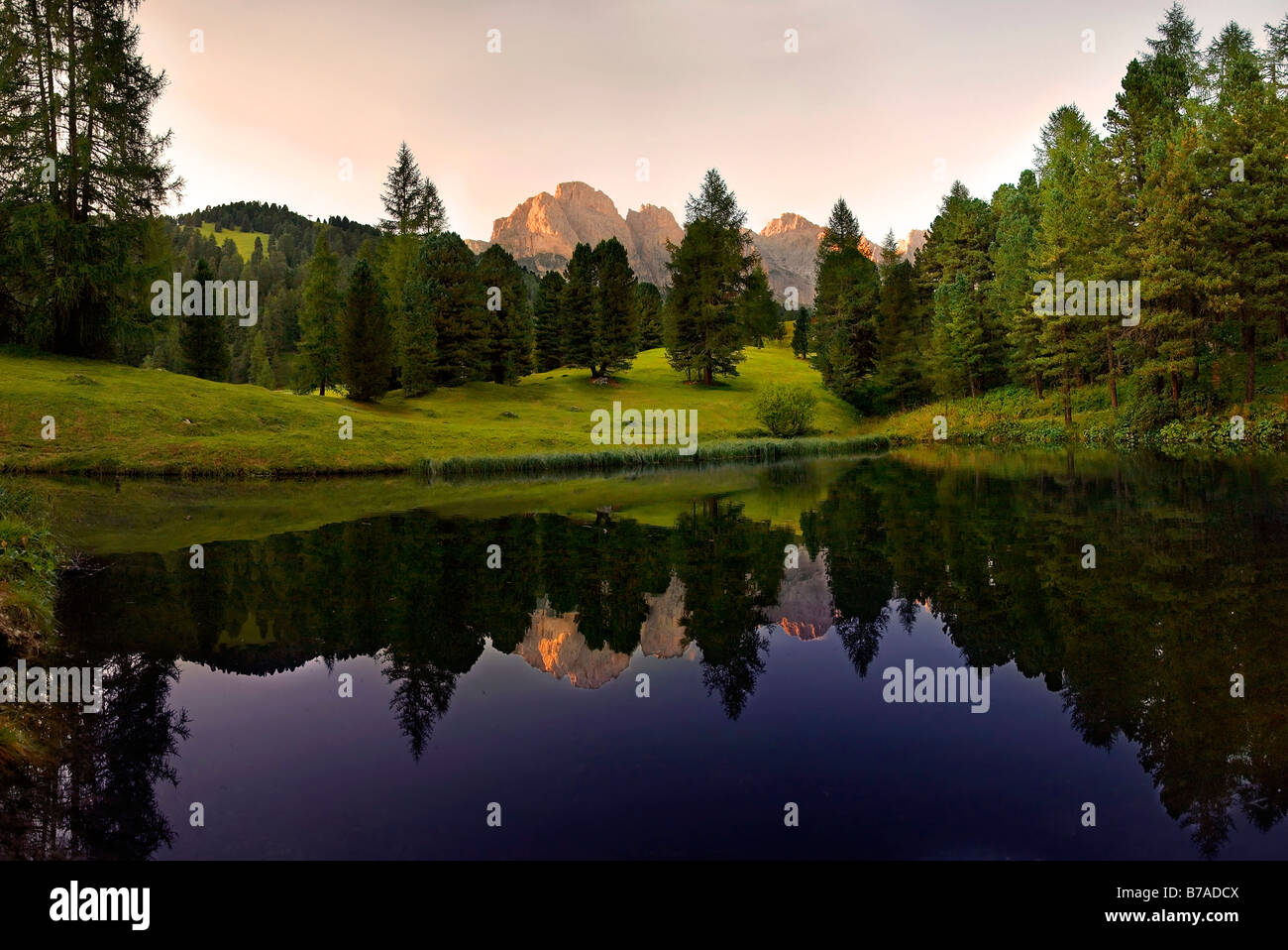 Small lake on the Seceda High Plateau with a reflection of the Geisler ...