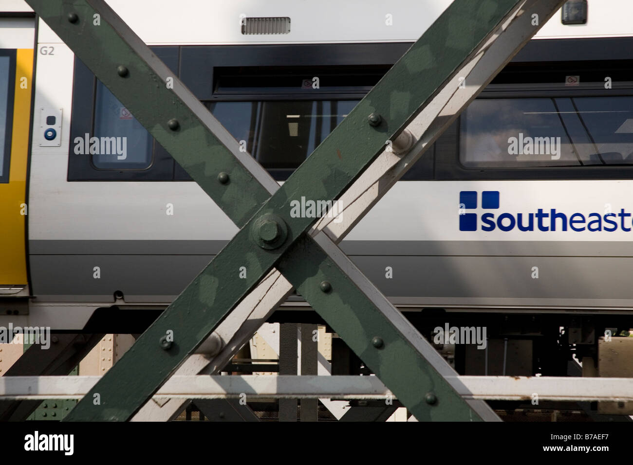 A train on the southeast rail network speeds over the river Thames on ...