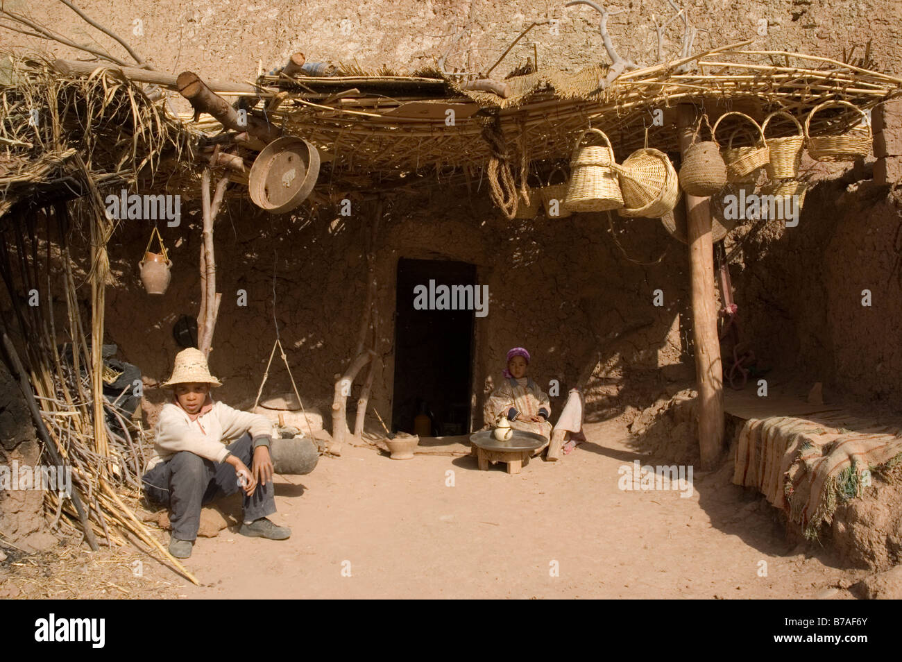 Moroccan Children Sitting outside mud hut at Ait Benhaddou Kasbah, near ...