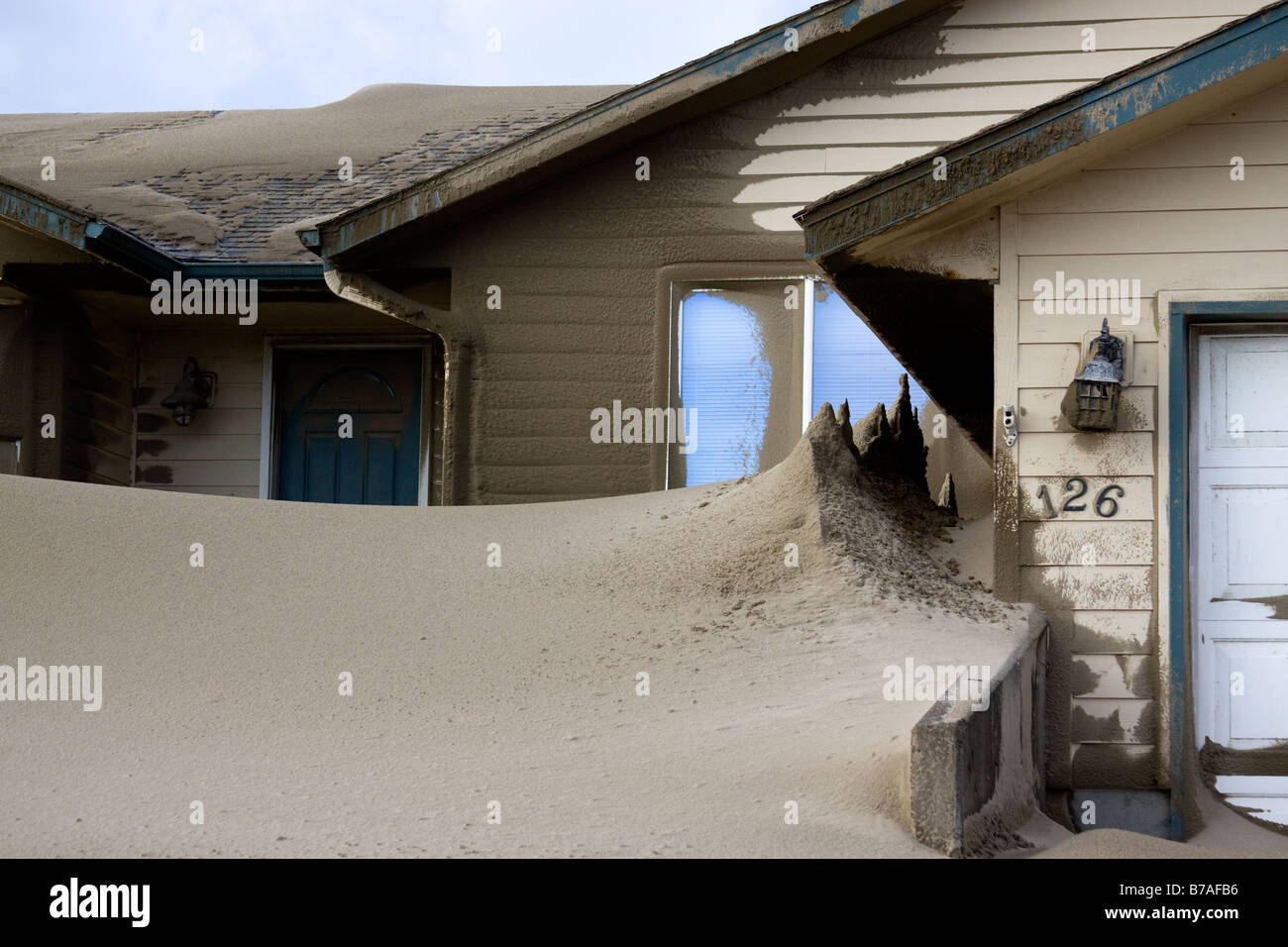 Sand almost buries a house after a large storm on the Oregon coast ...
