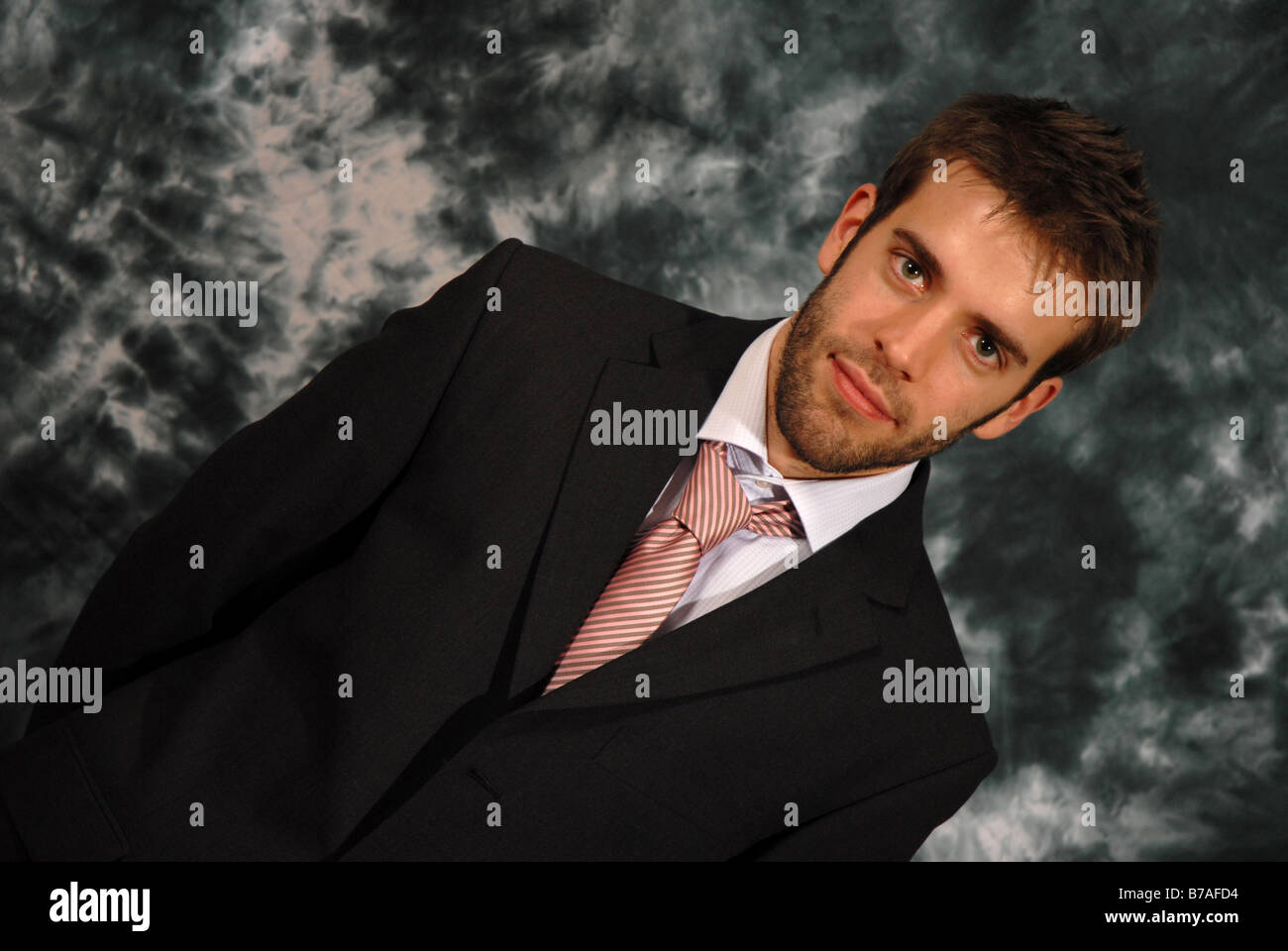 Portrait of a smart young man against a grey backdrop Stock Photo - Alamy