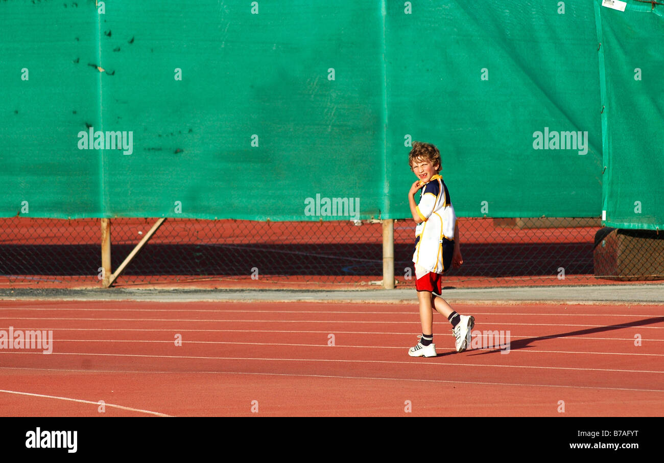 outdoor portrait of boy on running track Stock Photo - Alamy