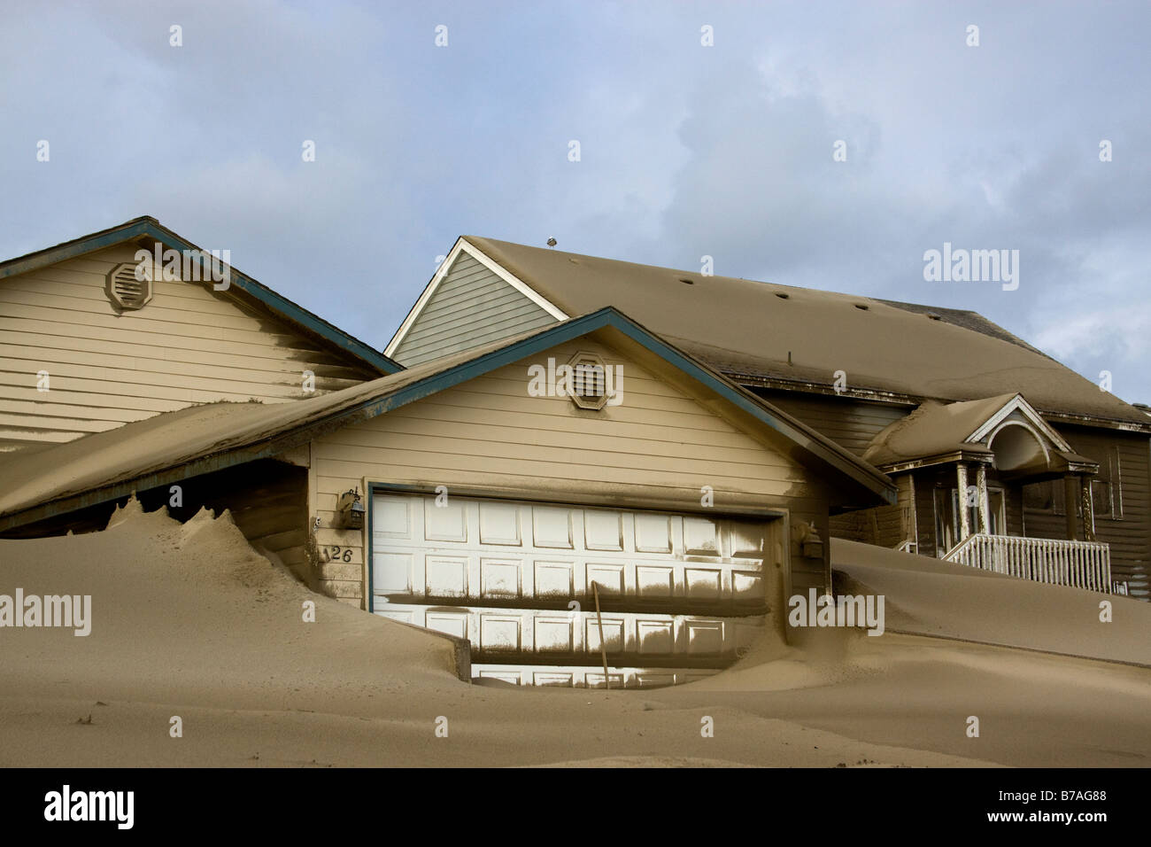 Sand almost buries a house after a large storm on the Oregon coast ...