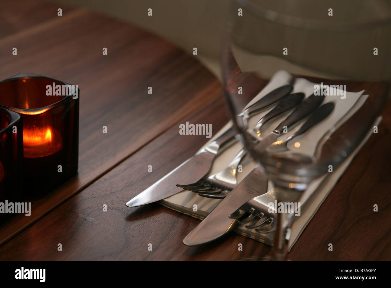 a still life photograph of some cutlery on a table in a exclusive ...