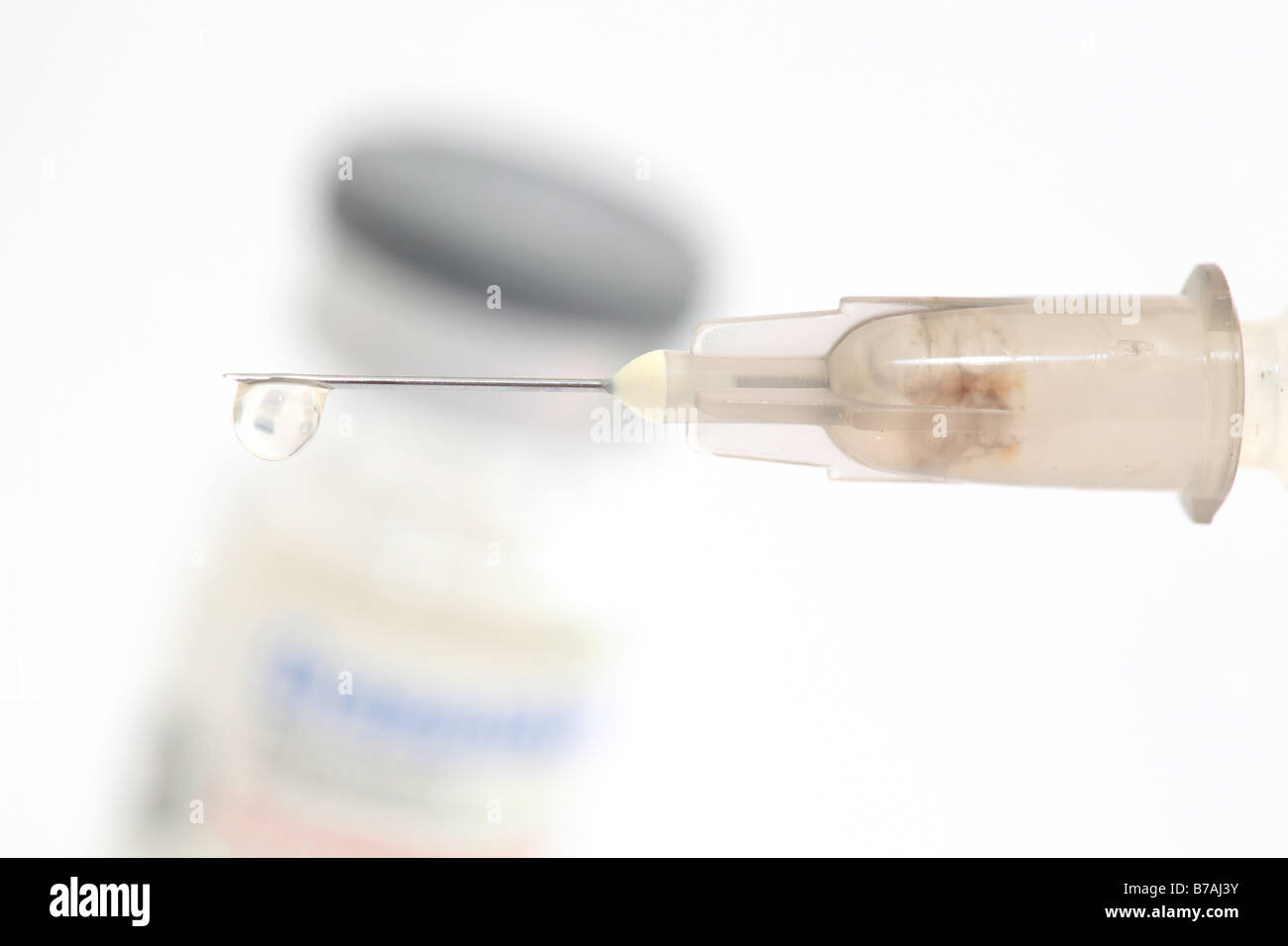medical injection syringe closeup detail with medicine drop and bottle ...
