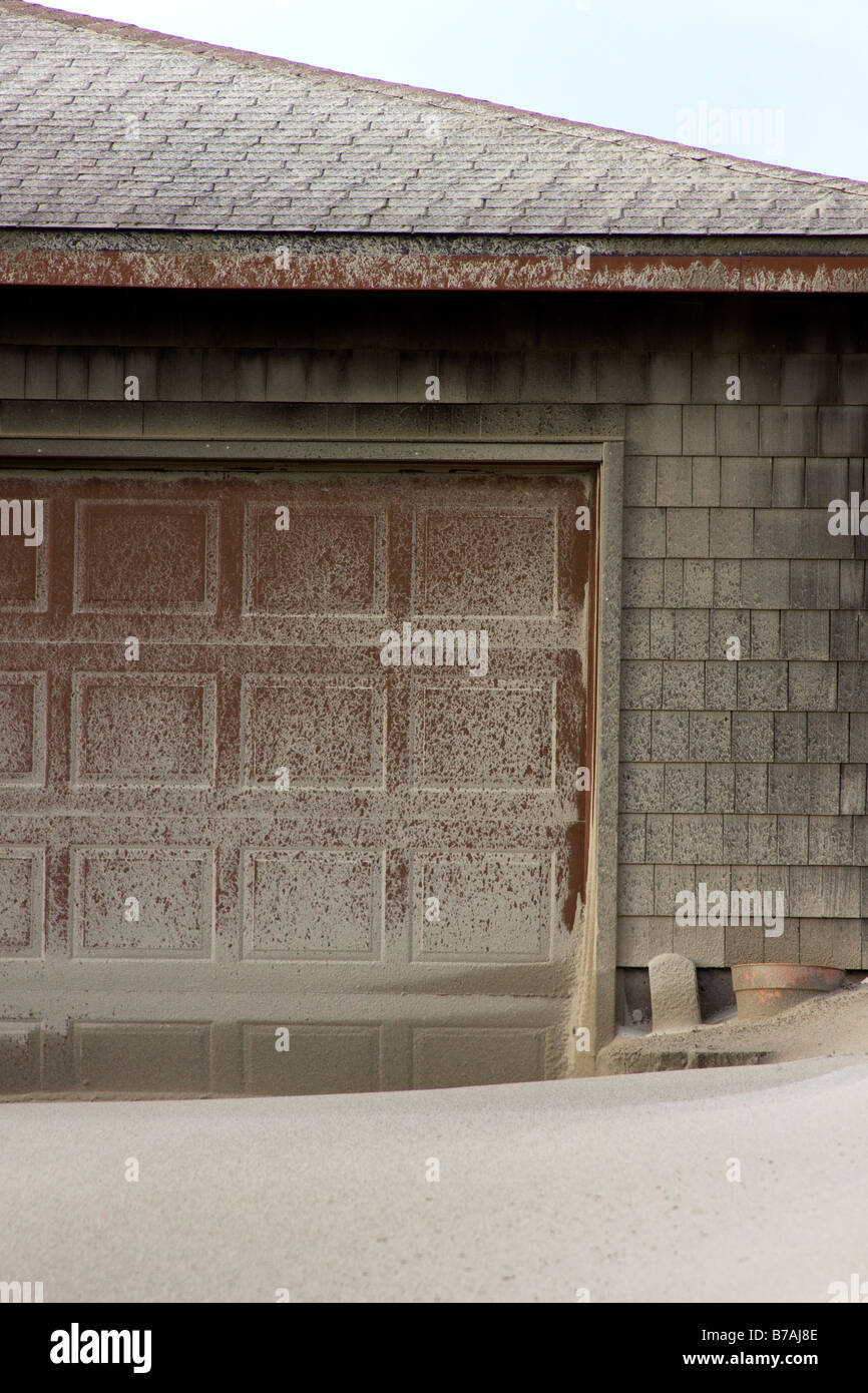 Sand piles up in front of a residence after a large storm on the Oregon ...