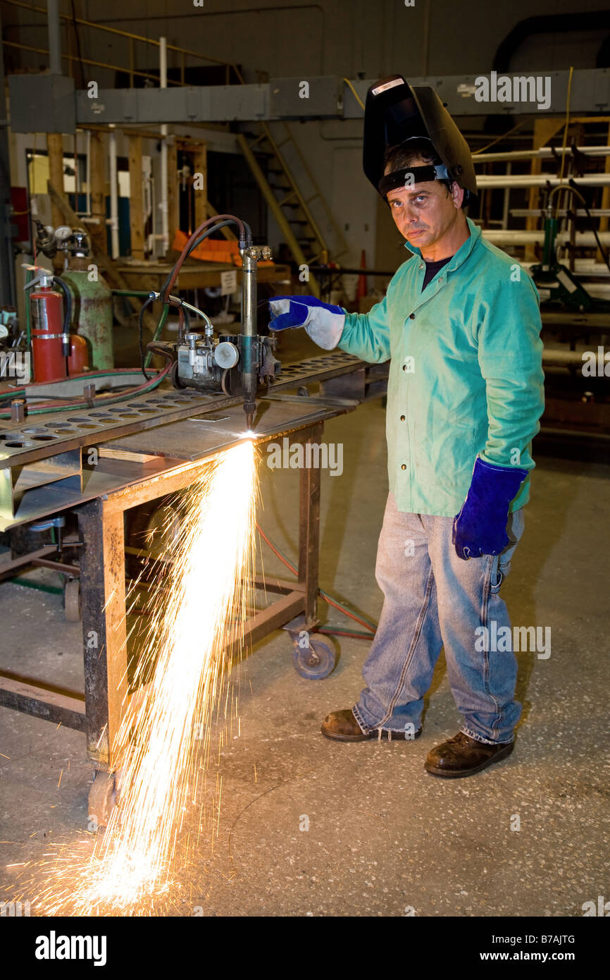 Metal worker using a track burner to cut steel with heat Stock Photo ...