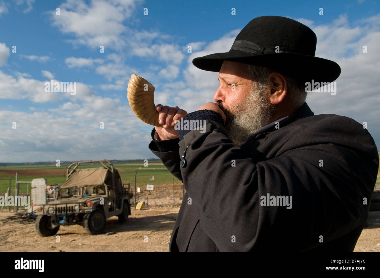 A religious Jew blows a bent ram’s horn Shofar encouraging Israeli ...