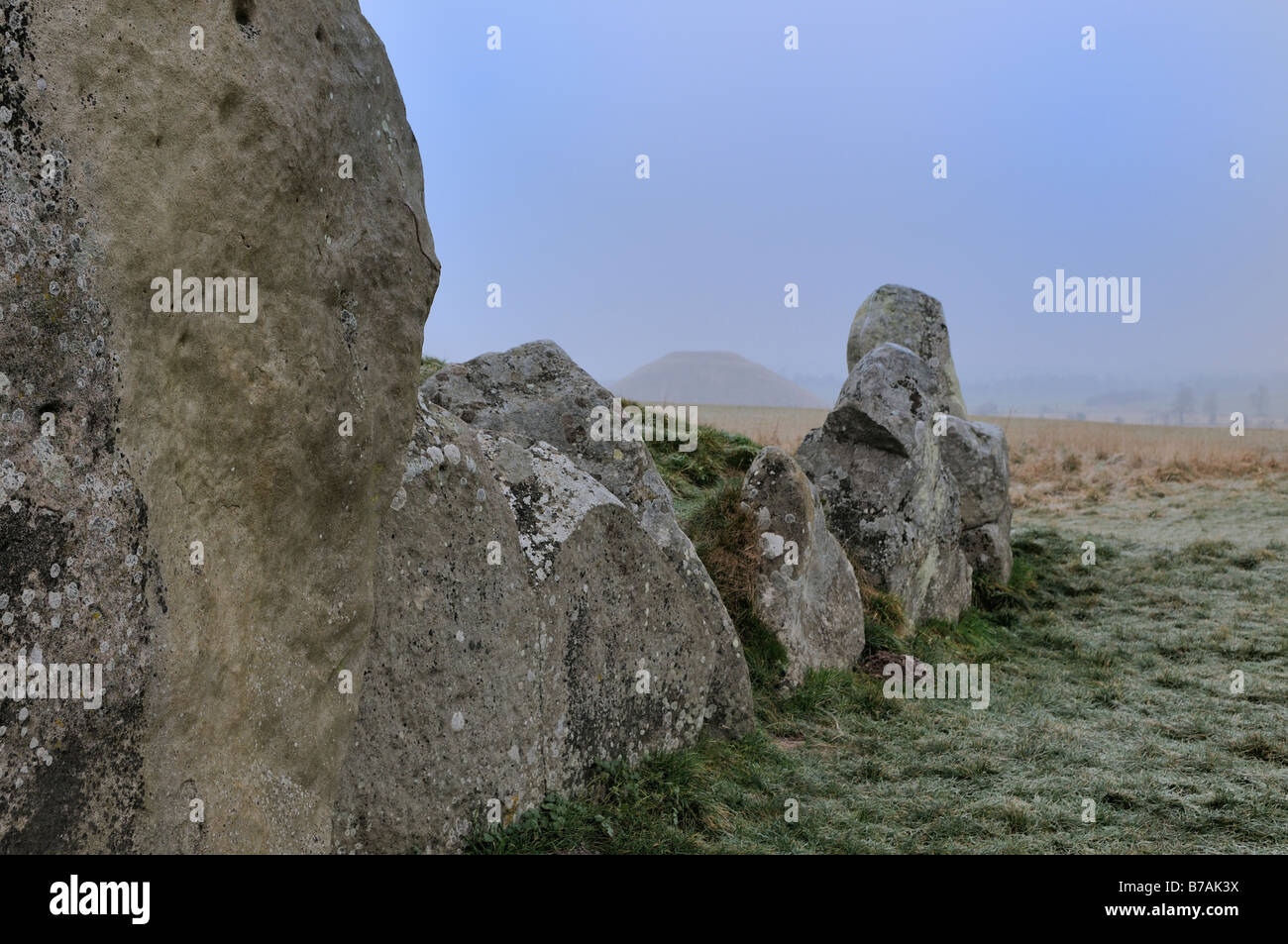 West Kennet long barrow with Silbury Hill in the distance - on a winter ...