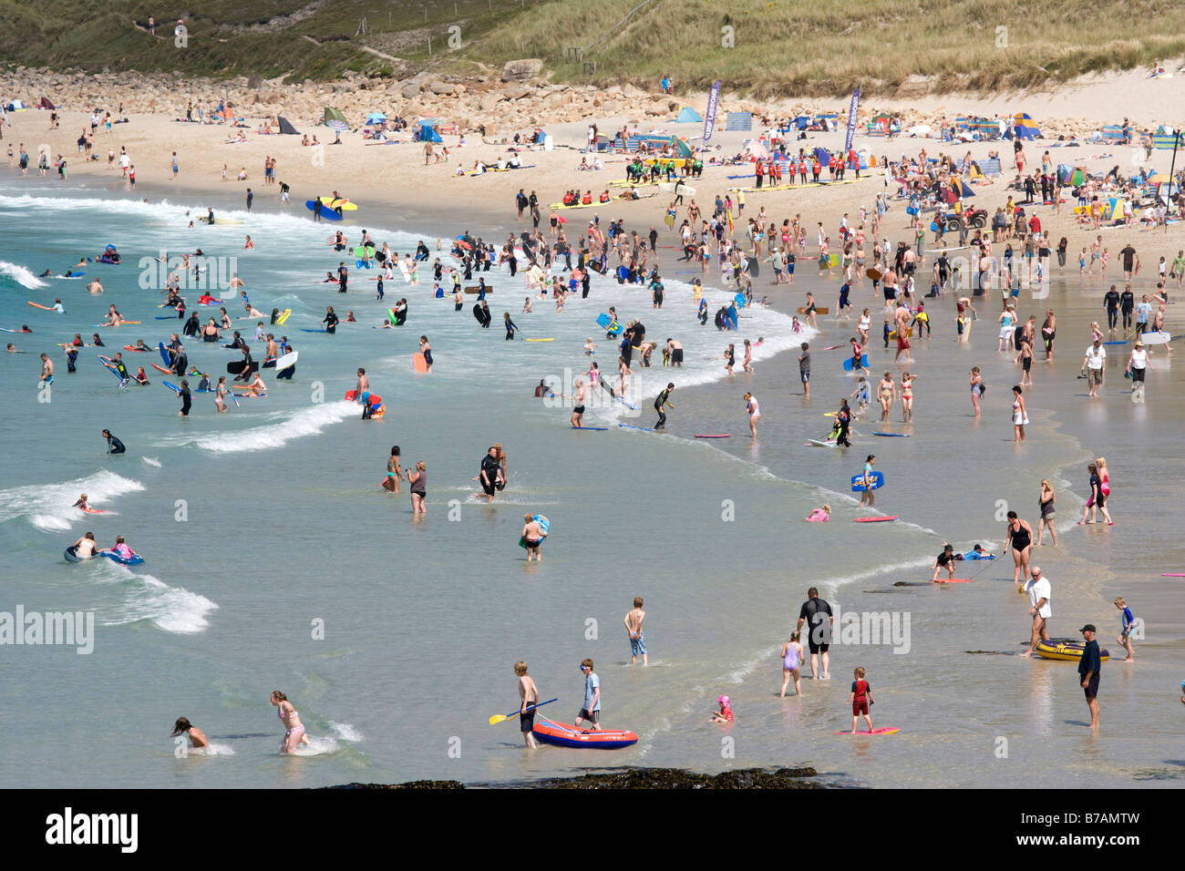 Holiday makers fill the beach at high tide in Sennen Cornwall Stock ...
