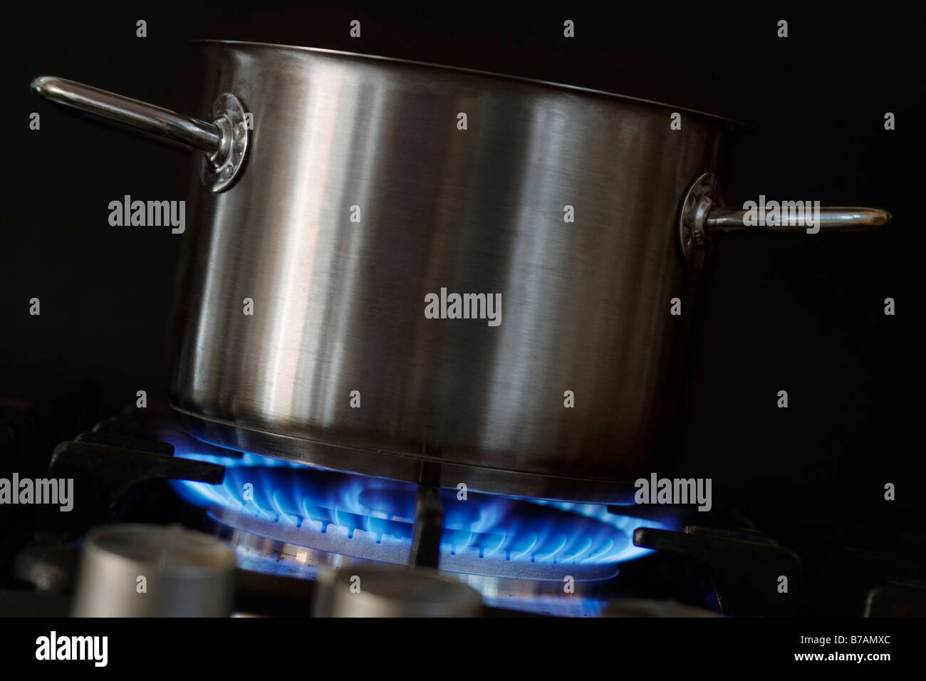Cooking pot on gas flame Stock Photo - Alamy
