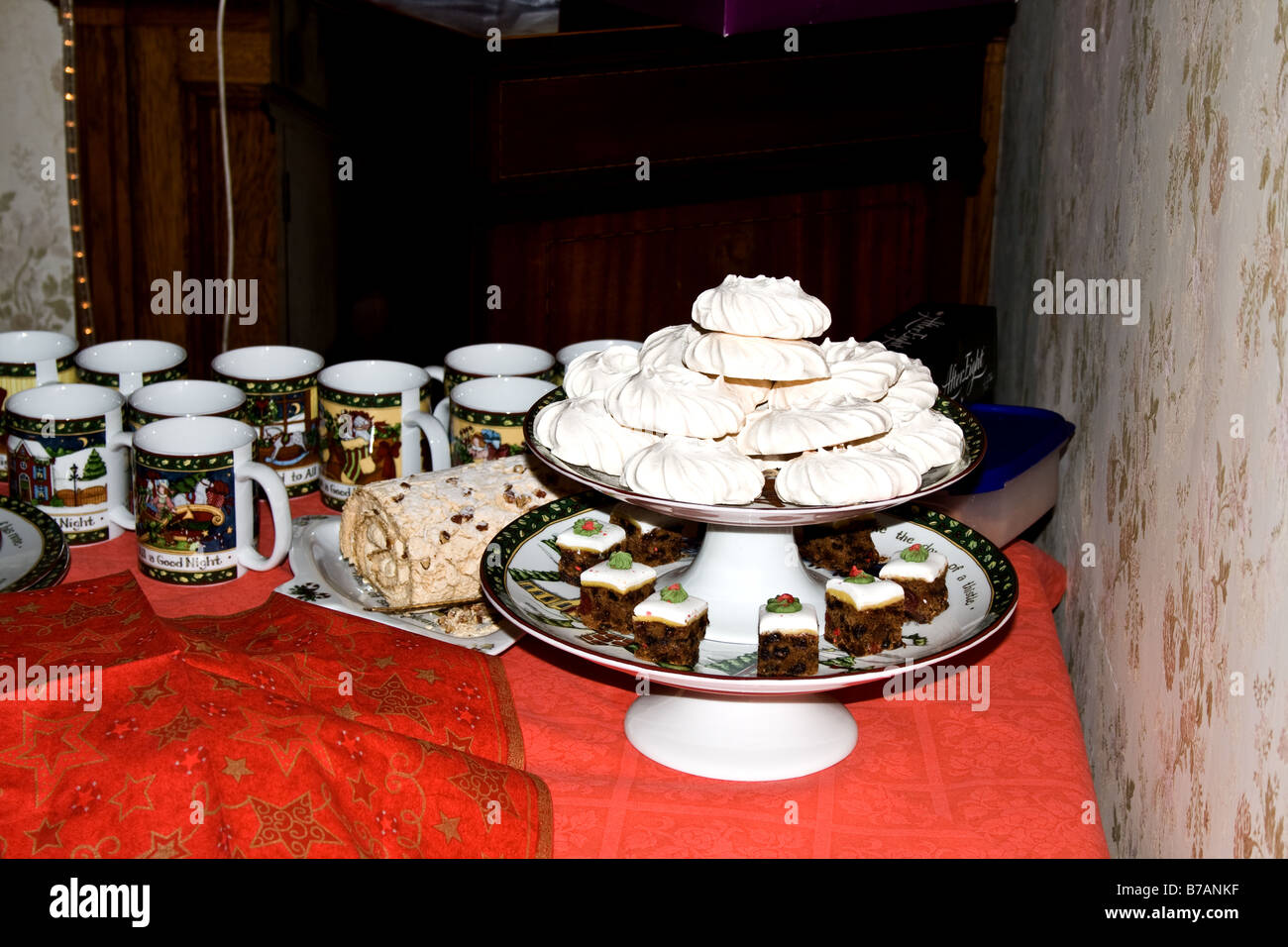 Bi-level cake plate with meringues on top and small cakes on the bottom ...