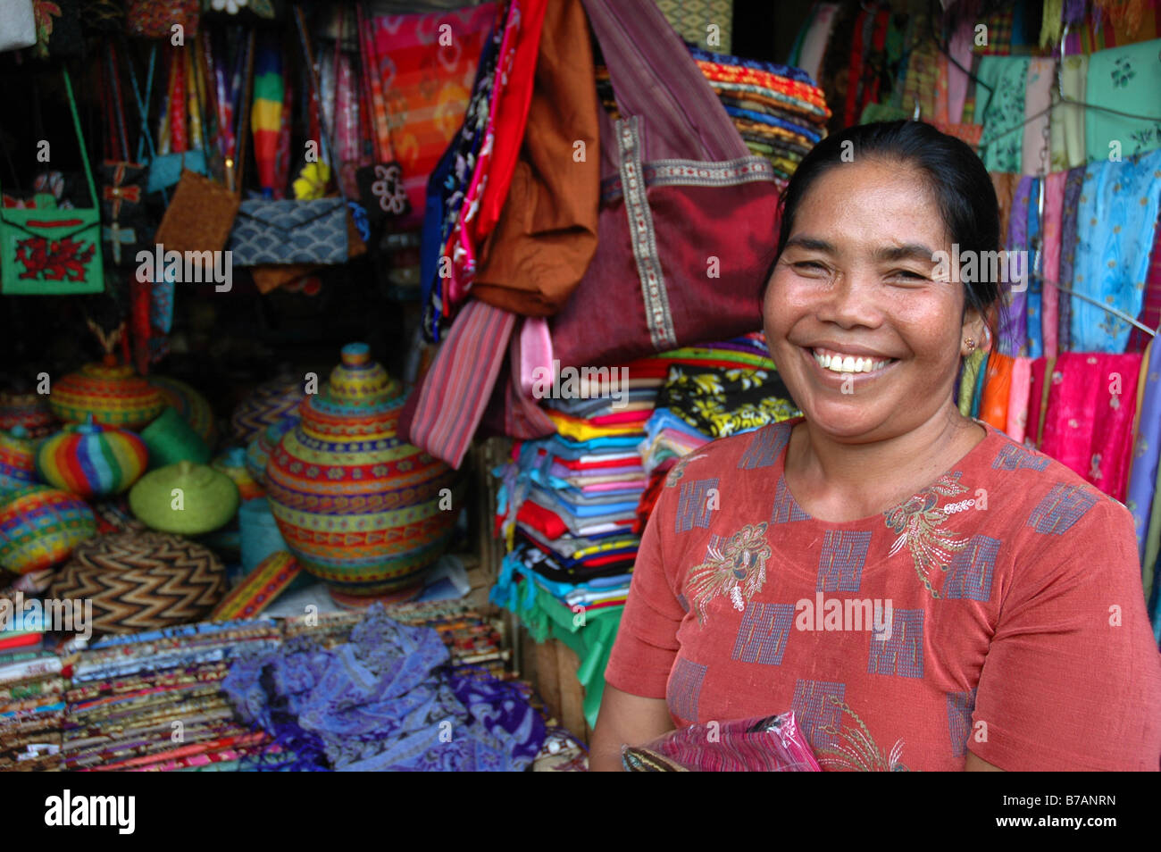 A stall owner at a market in Ubud, Bali poses for the camera Stock ...