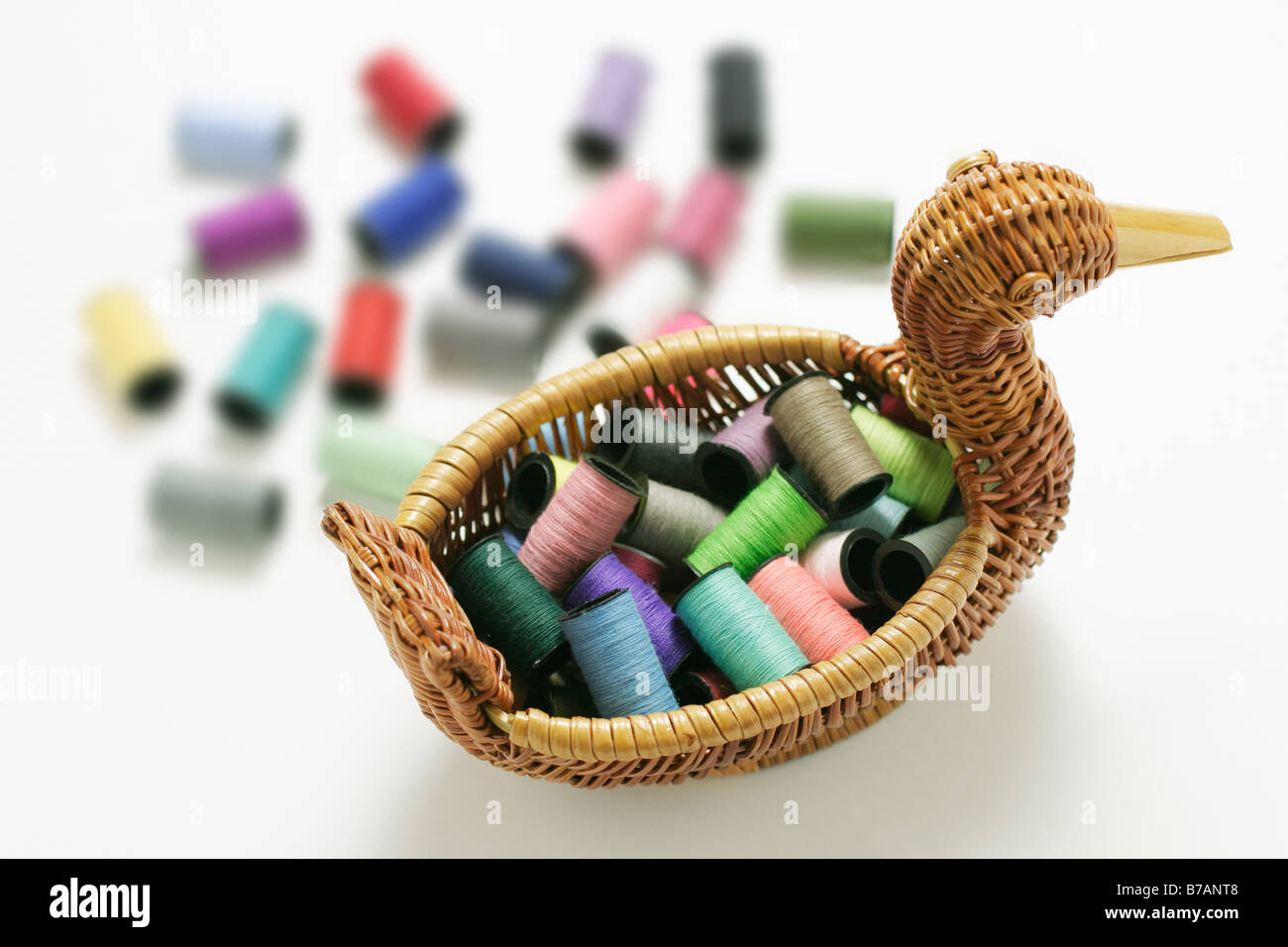 Spools of thread in basket Stock Photo - Alamy