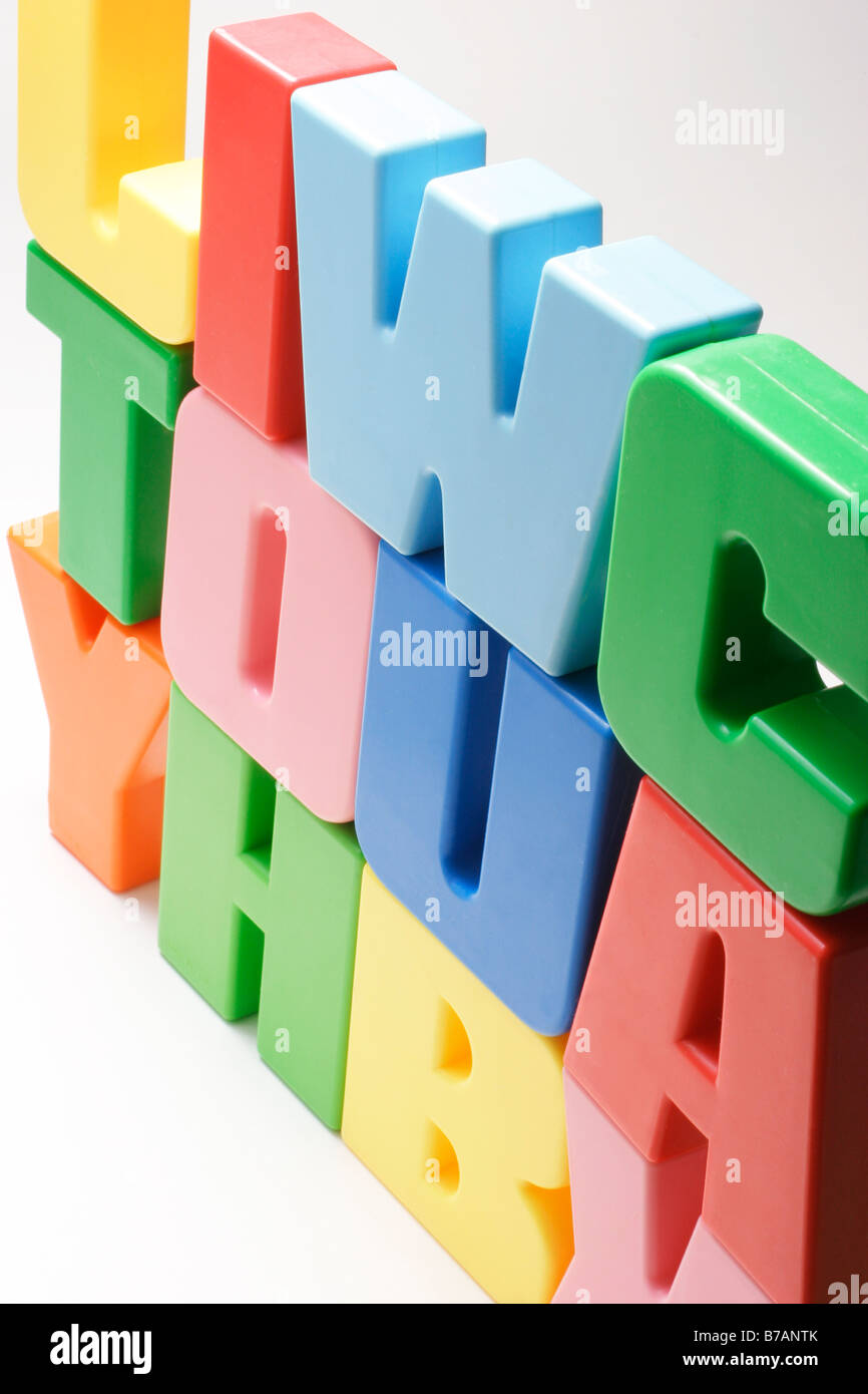 Stacked colored plastic letters of the alphabet Stock Photo - Alamy
