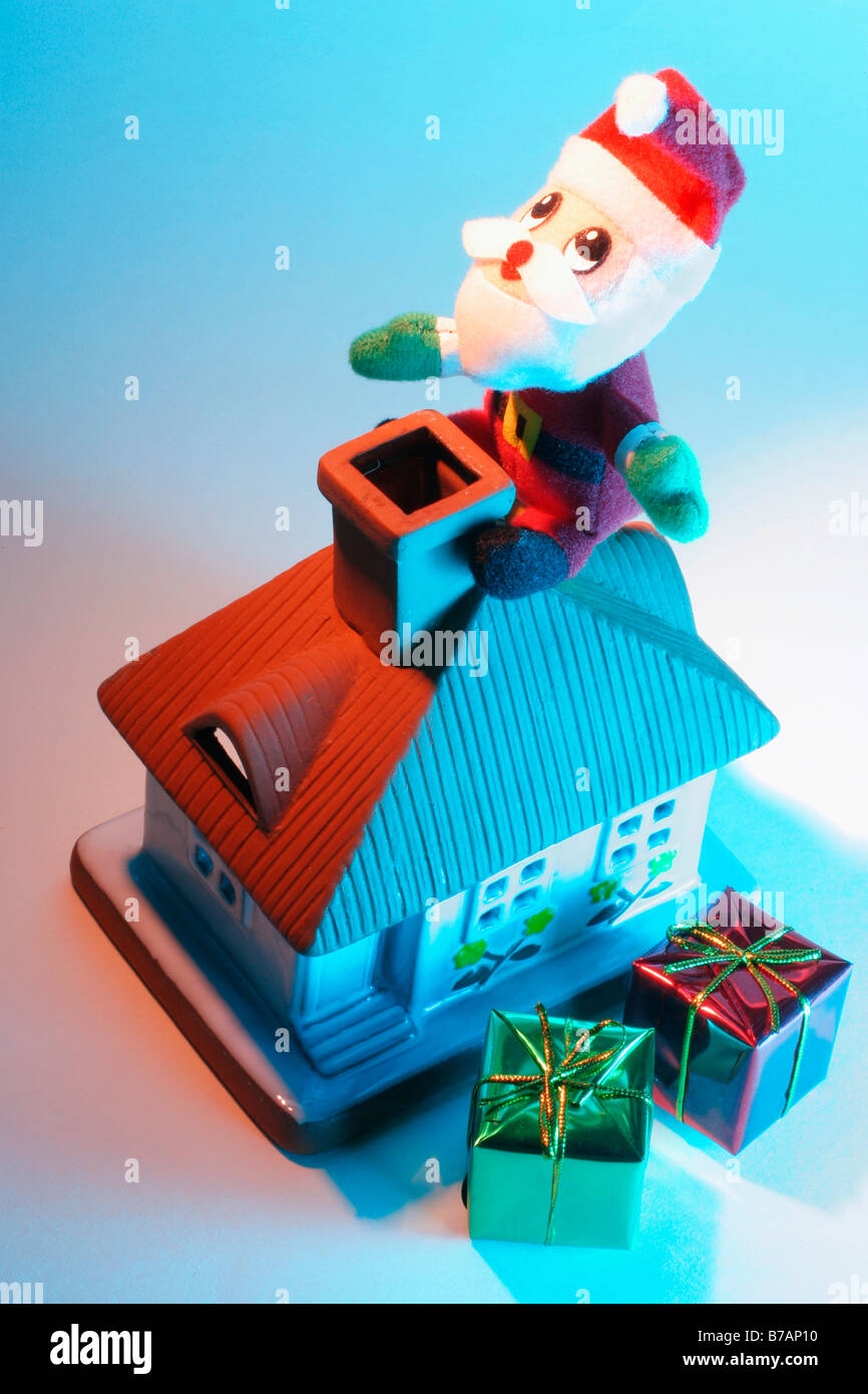 Santa figurine on top of toy house chimney Stock Photo - Alamy