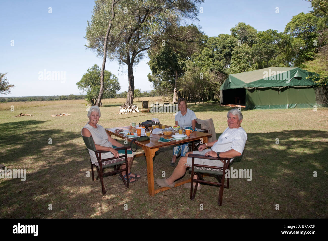 Tourists dining outside at Duma tented camp Masai Mara North Reserve ...