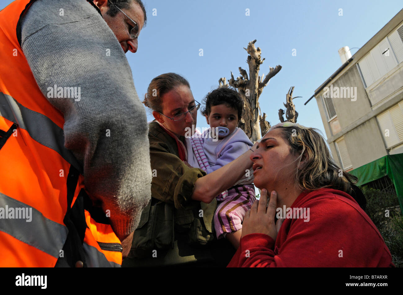 An Israeli military medic comforts an Israeli civilian in shock after ...
