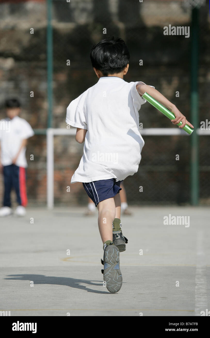 “Asian school boy running in a sports lesson Stock Photo - Alamy