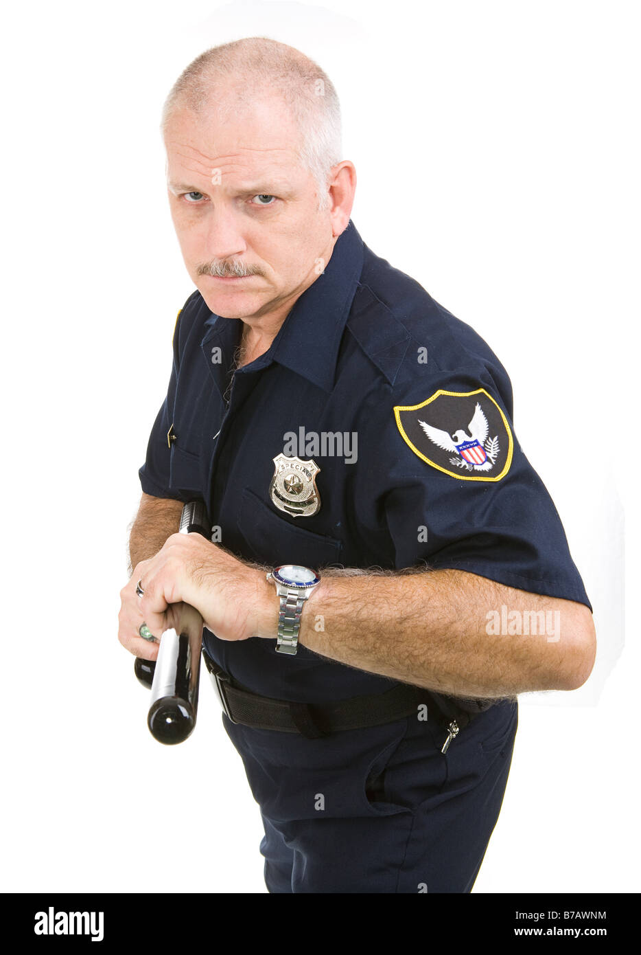 Police officer in an aggressive posture ready to use his night stick ...
