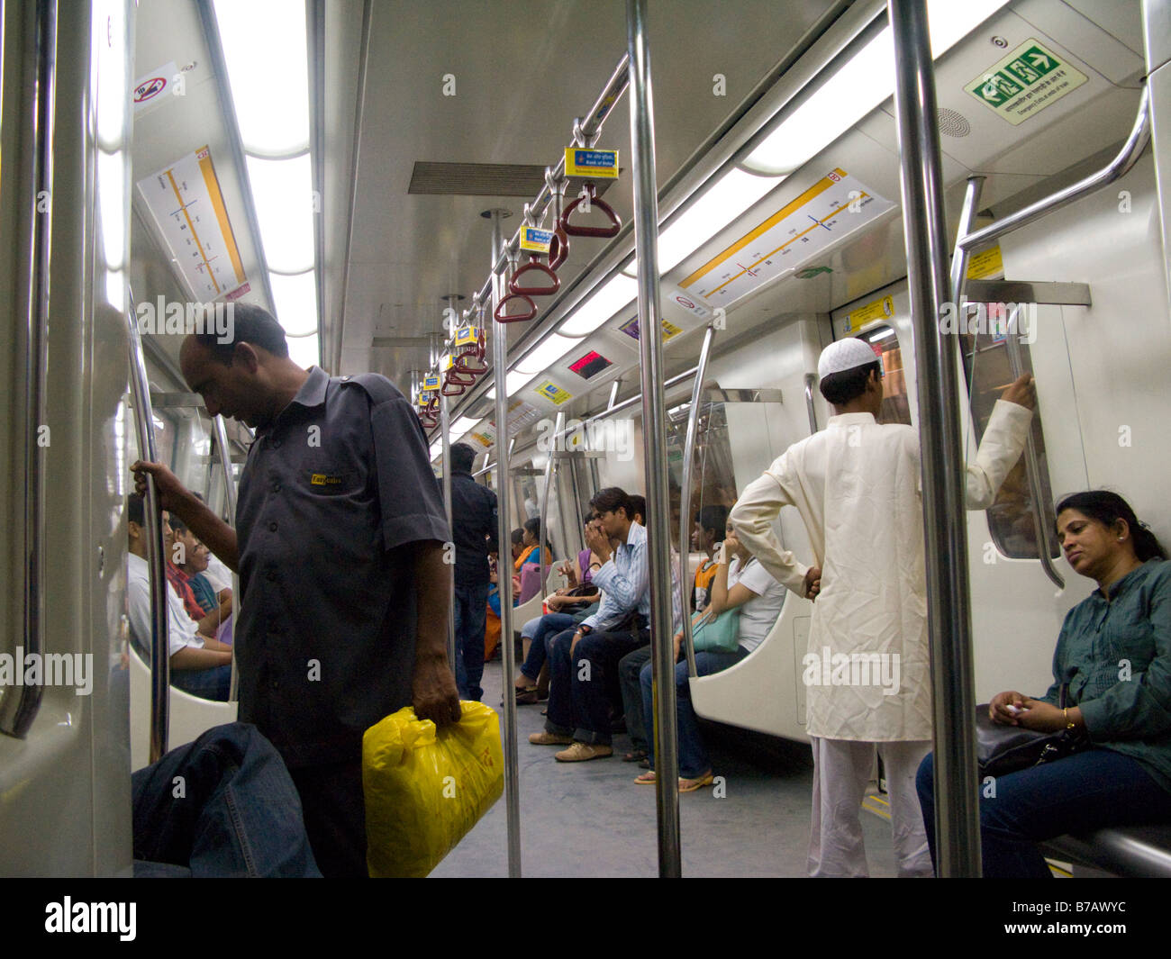 A yellow line tube train carriage interior with passengers. Delhi Metro ...