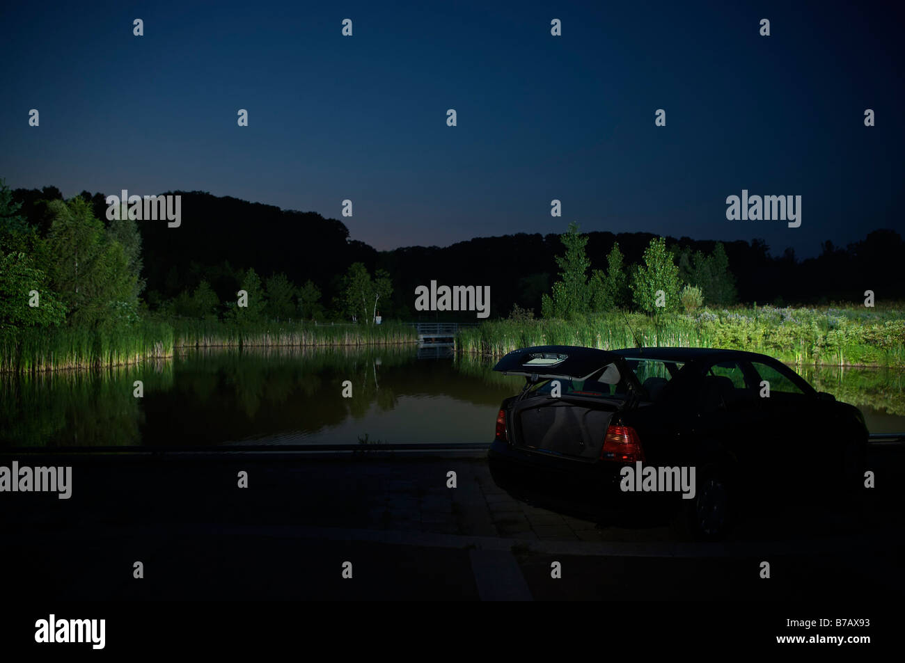 Car With Open Trunk Parked by Lake at Night Stock Photo - Alamy