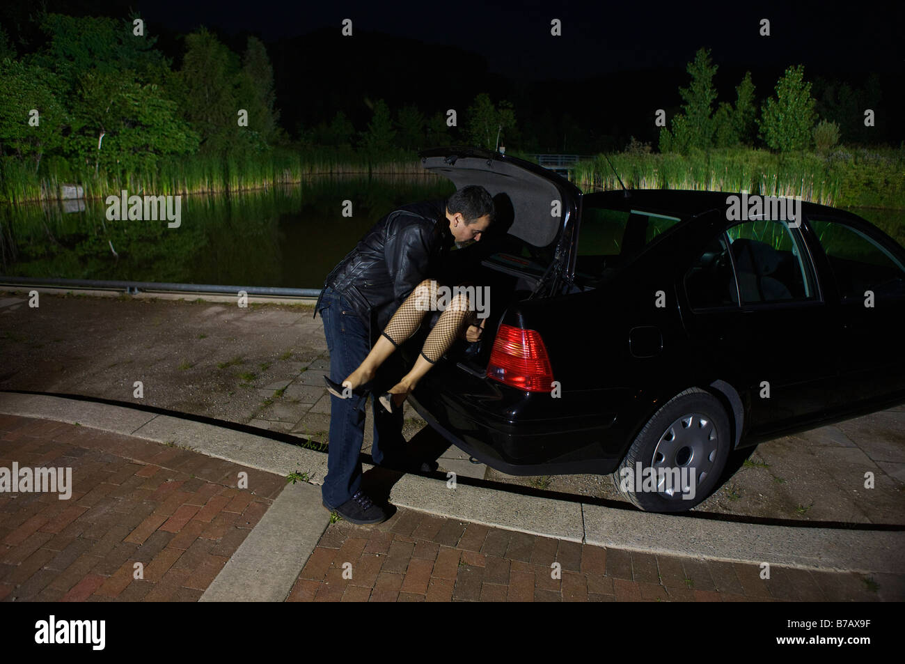 Man Disposing of Woman's Body Stock Photo - Alamy