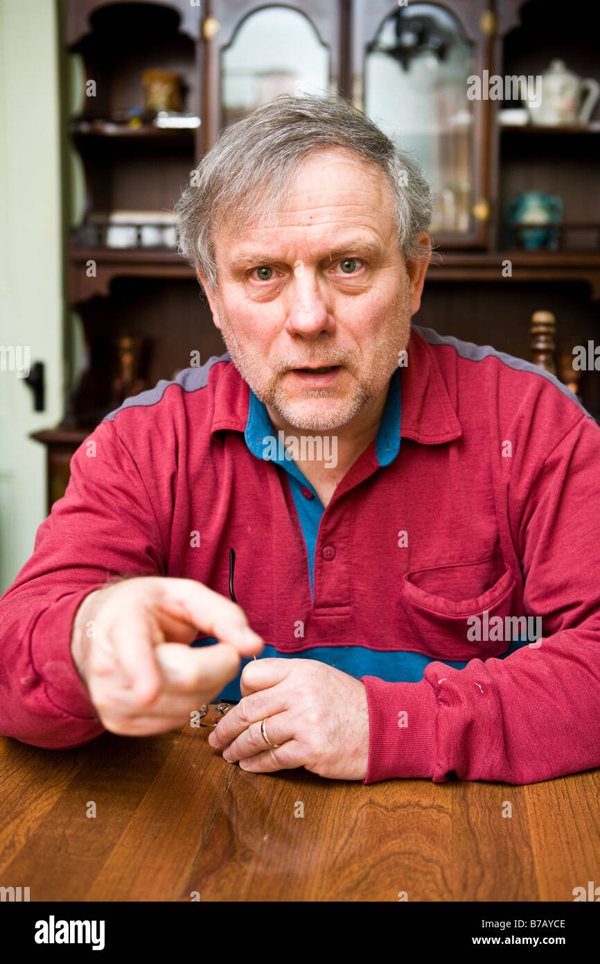 A man talking from accross the table Stock Photo - Alamy