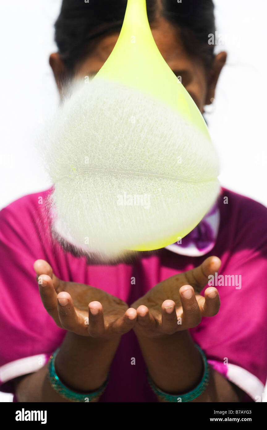 Indian girl catching a burst water balloon. Andhra Pradesh. India Stock ...