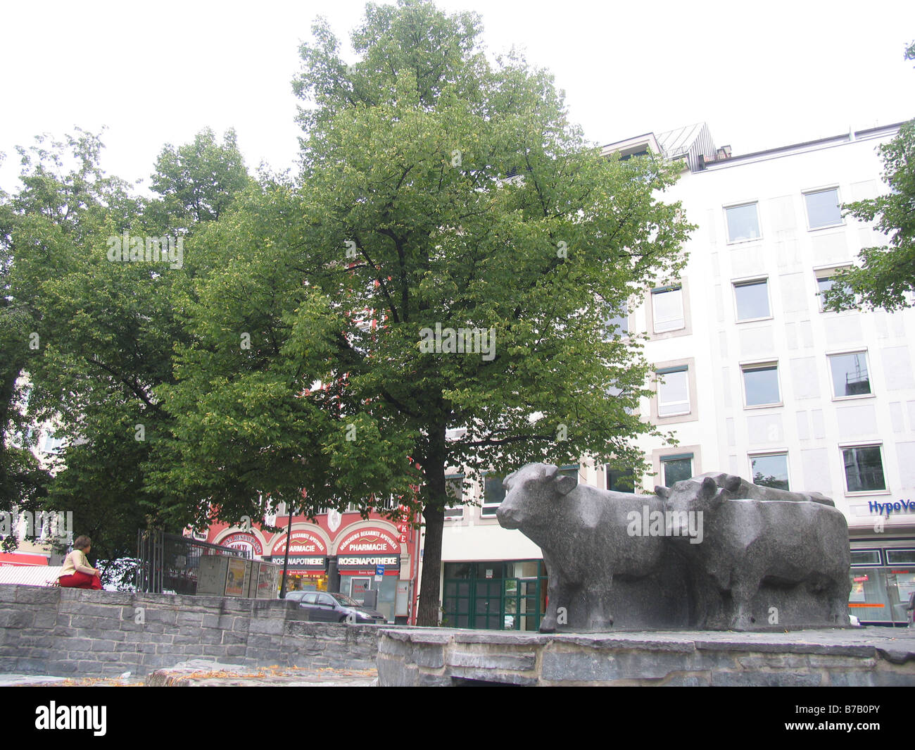 Square at Munich, Germany, with trees and sculptures Stock Photo - Alamy