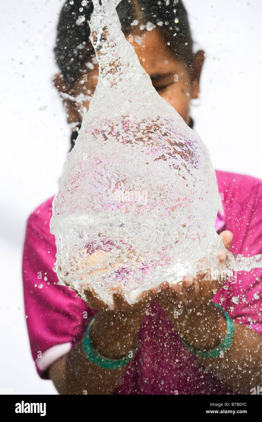 Indian girl catching a burst water balloon. Andhra Pradesh. India Stock ...