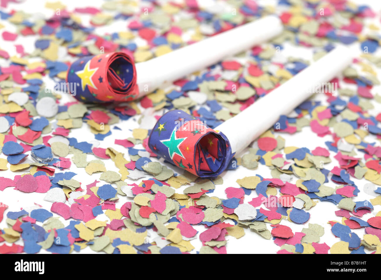 celebration and party two blowers on paper confetti Stock Photo - Alamy