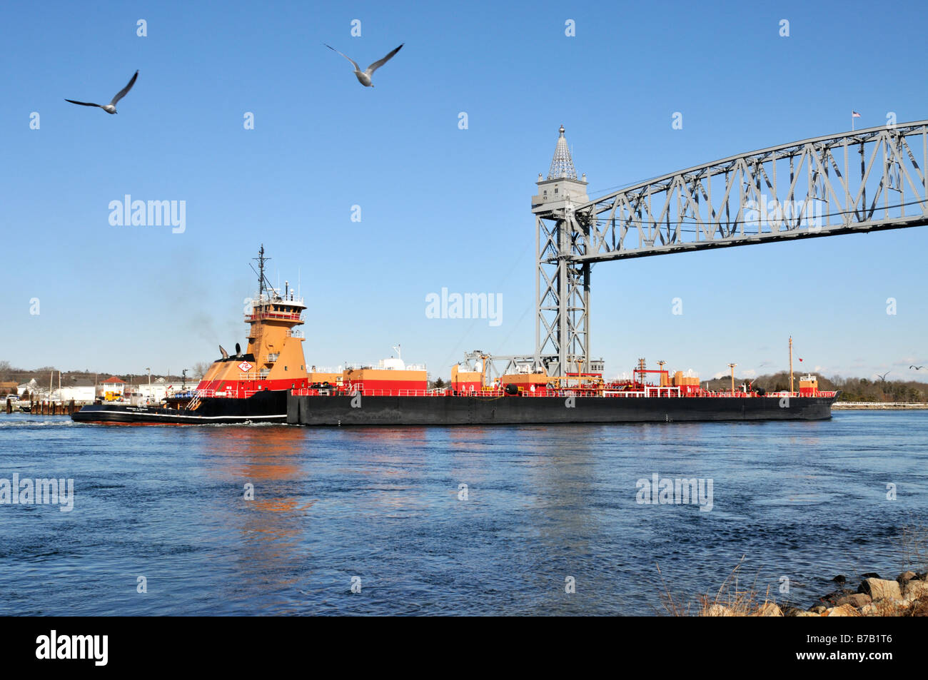 Tugboat and fuel oil barge in Cape Cod Canal with Railroad bridge and ...
