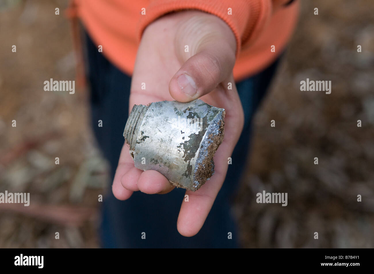 An Israeli civilian holds a shrapnel of a Kassam rocket fired from Gaza ...