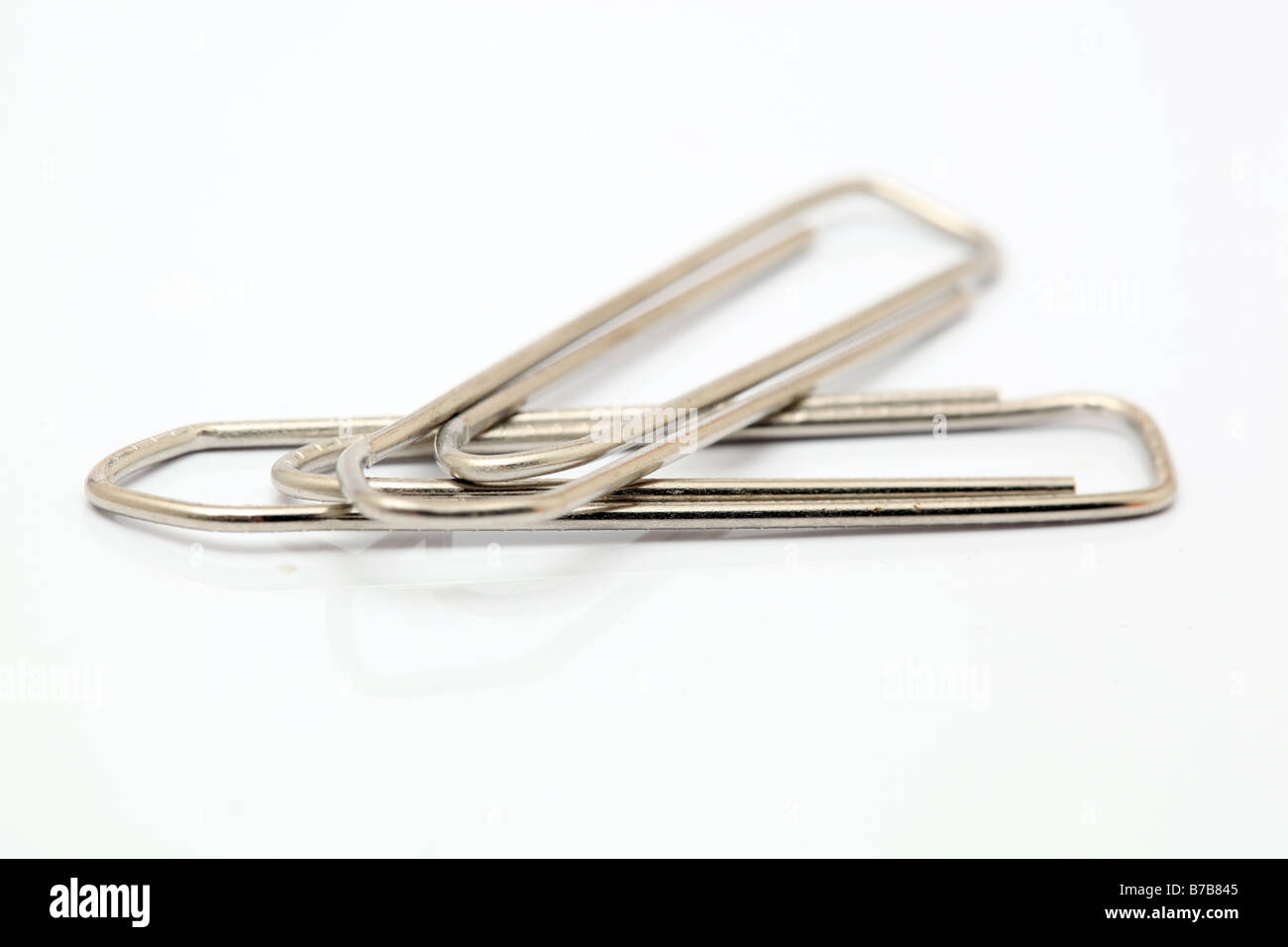 closeup two metallic paper clips isolated on white background Stock ...