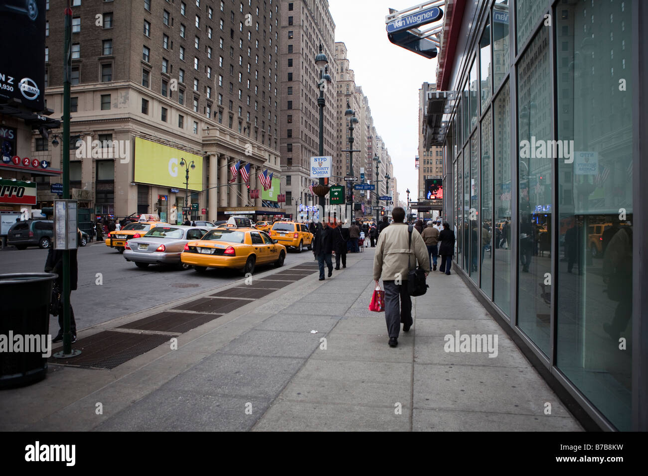 people walking on a street of new york manhattan with day traffic and ...