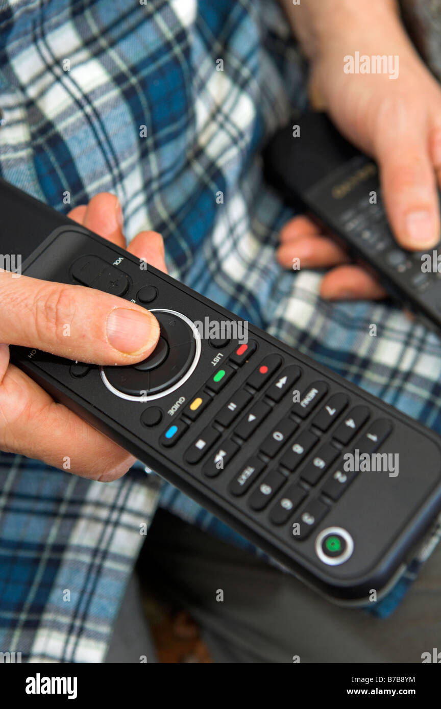 Using remote controls for watching television Stock Photo - Alamy