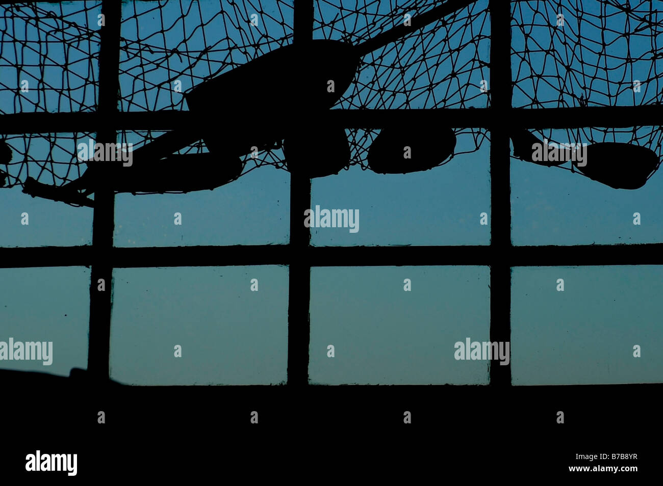 Fishing nets draped across the top of a window Stock Photo - Alamy