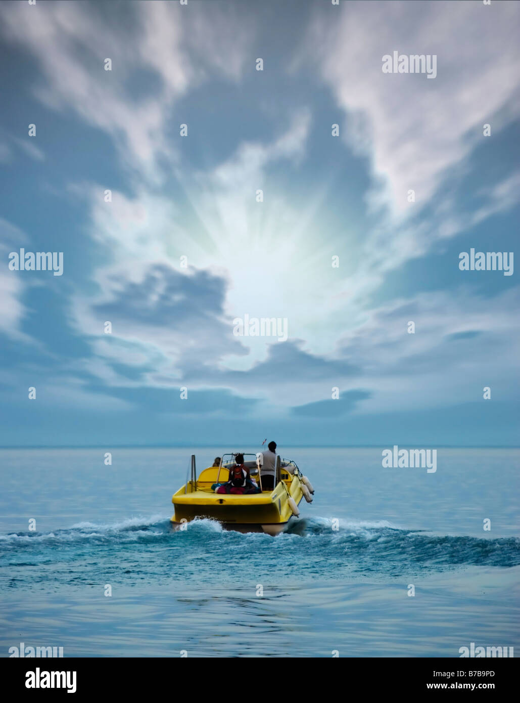 Boat at ocean floating towards to fantastic sunset Stock Photo - Alamy