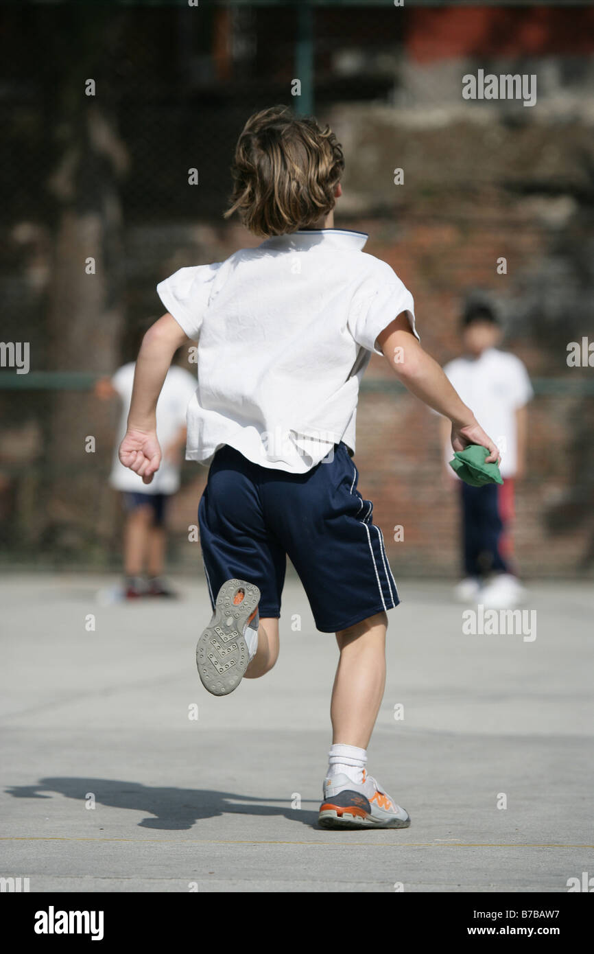 “School boy running in a sports lesson Stock Photo - Alamy