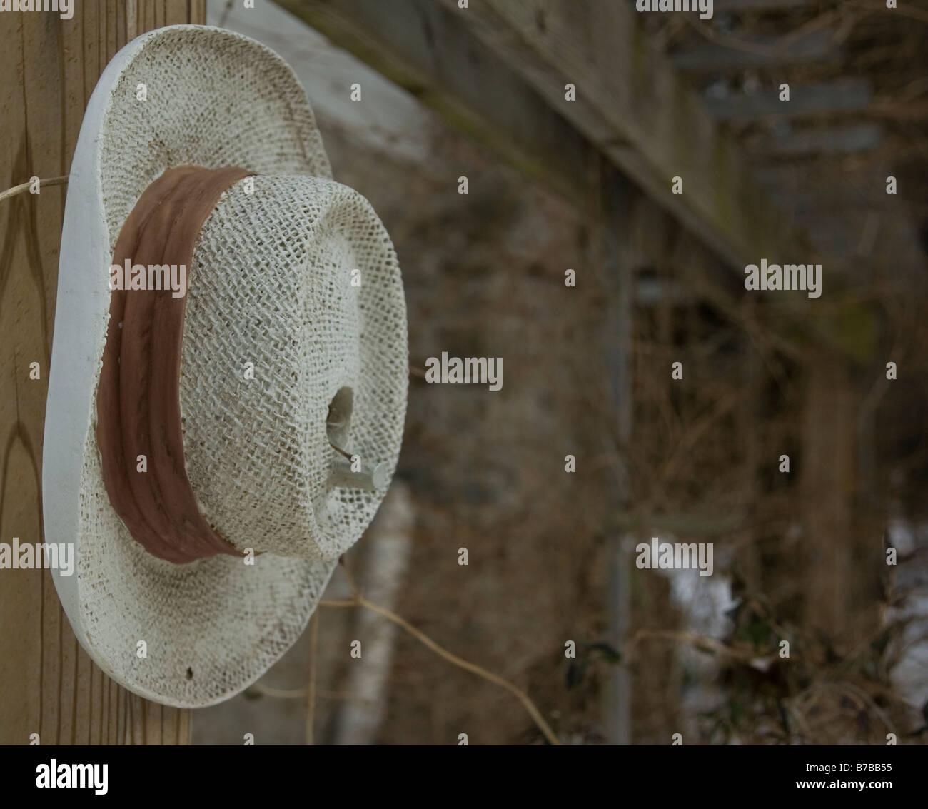 Straw hat used as a birdhouse Stock Photo - Alamy