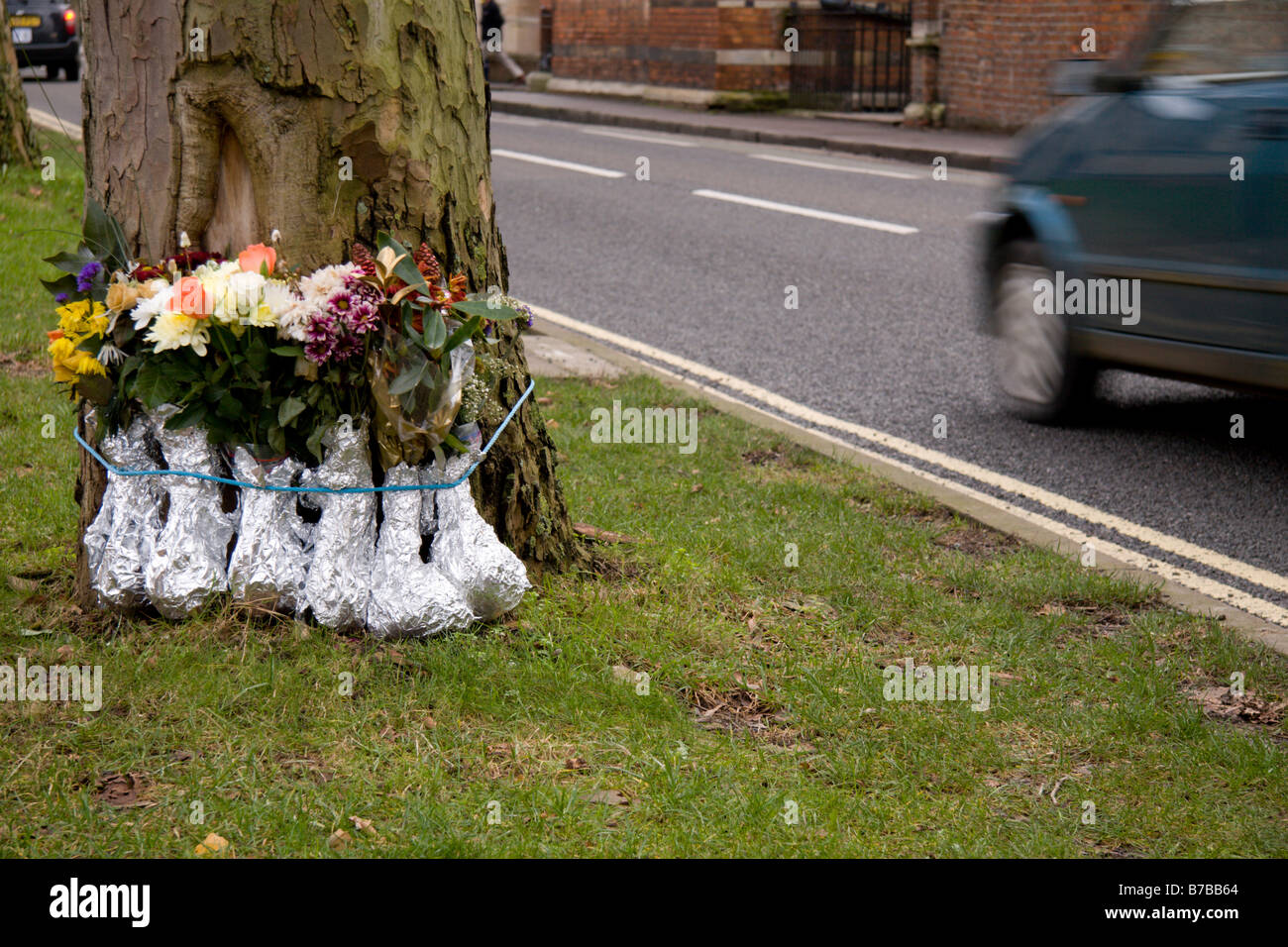 A car passing a flower memorial to an accident victim on Parks Road ...