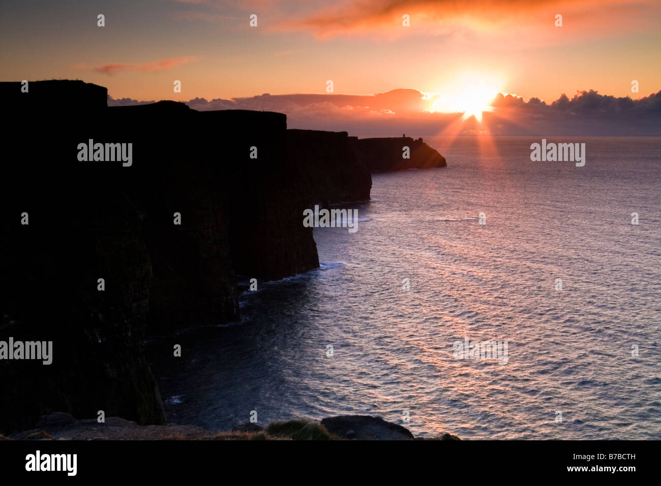 sunset over the cliffs of moher, in county clare, ireland Stock Photo ...