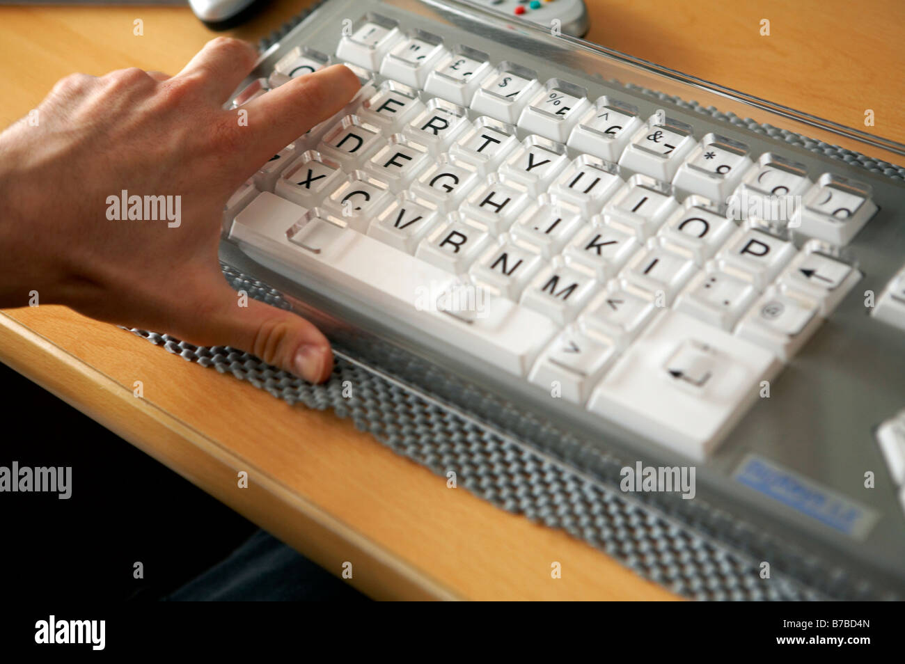 A disabled man used a specical designed keyboard Stock Photo - Alamy
