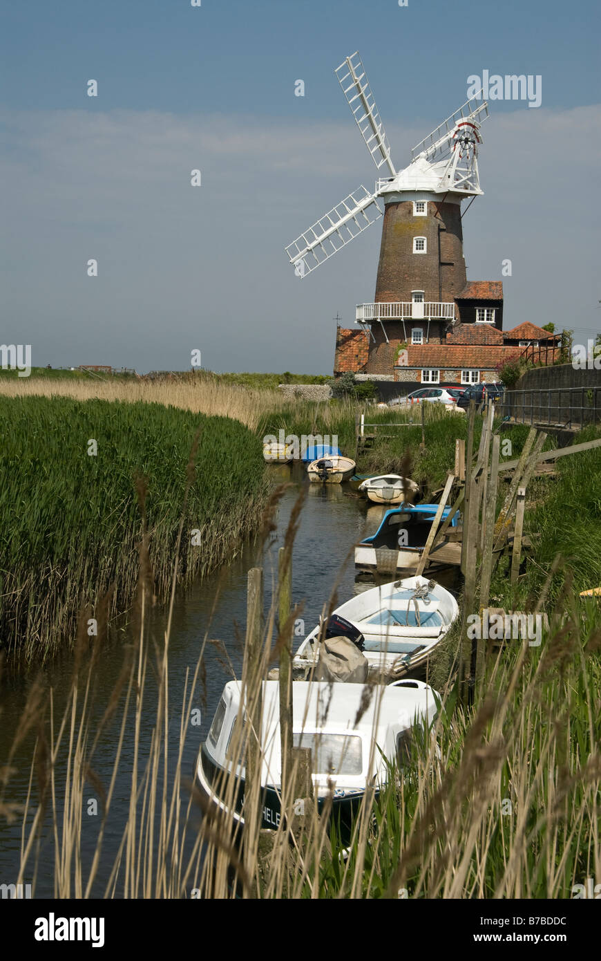 Cley Mill, river inlet, boats and marshland at Cley next the Sea ...