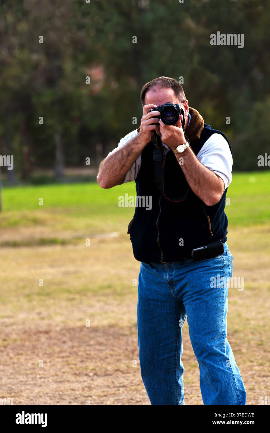 Male caucasian photographer pointing camera straight on the camera ...