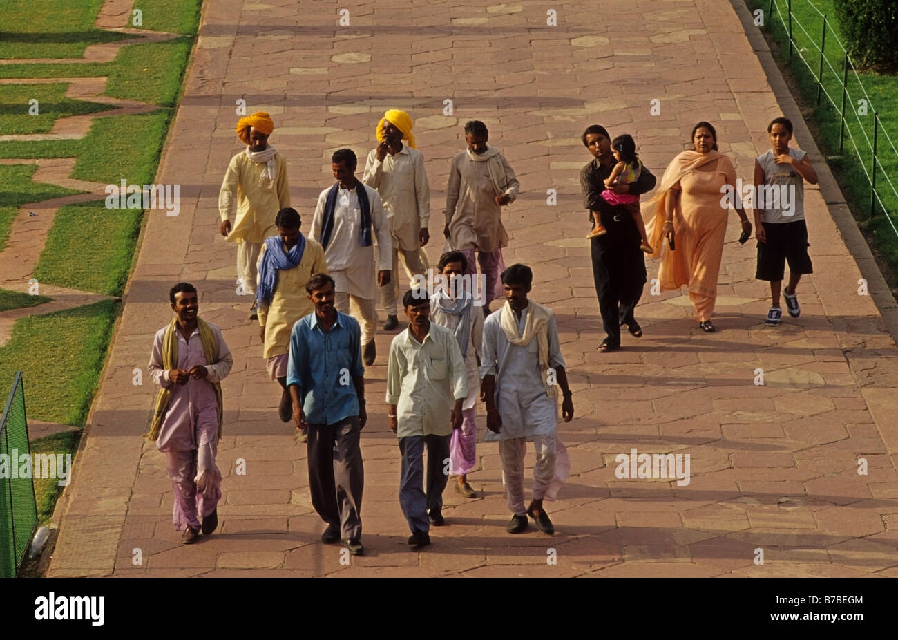 A group of Indian tourists strolling through the park surrounding the ...