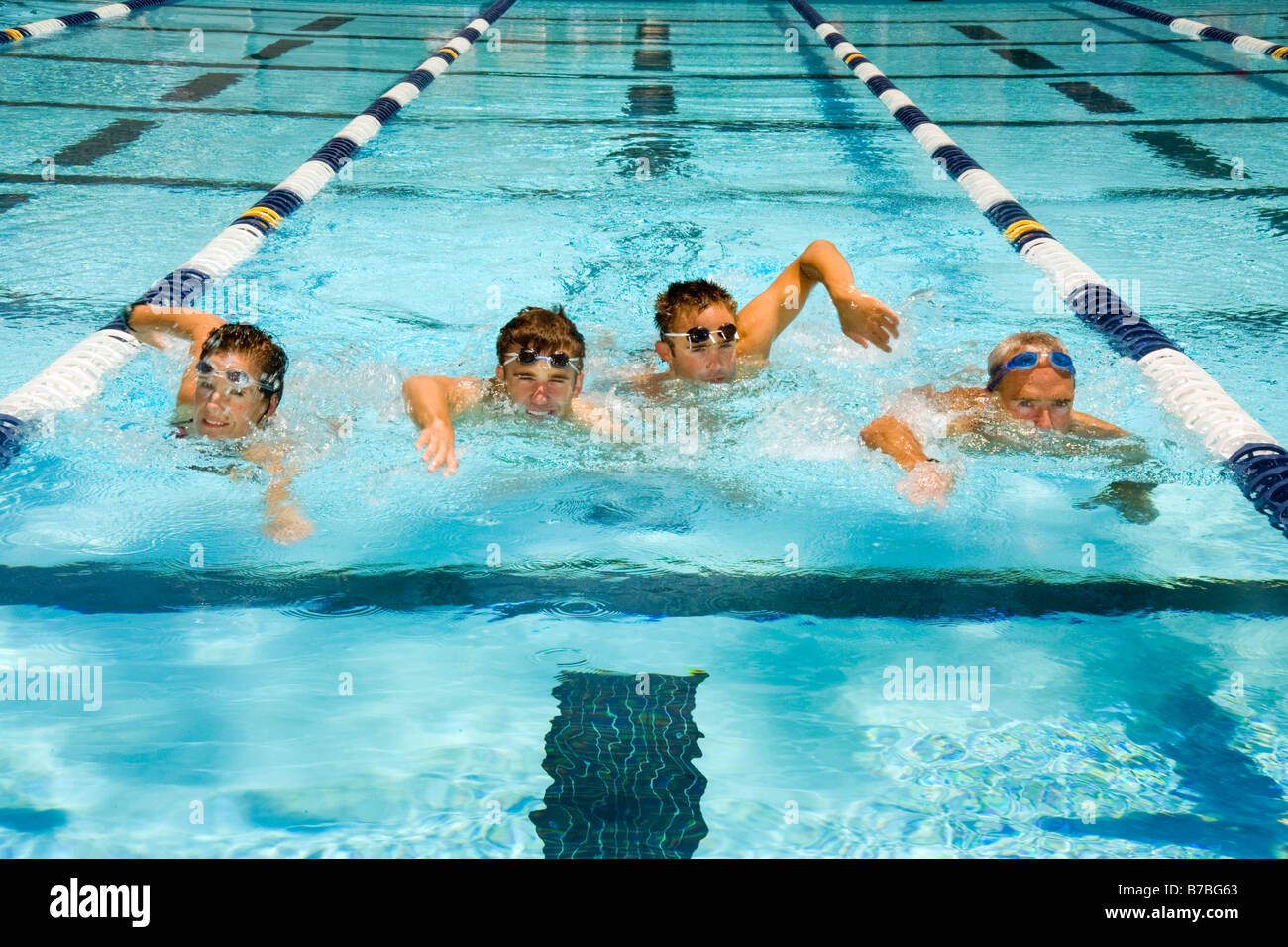 Family of four standing in swimming pool Stock Photo - Alamy